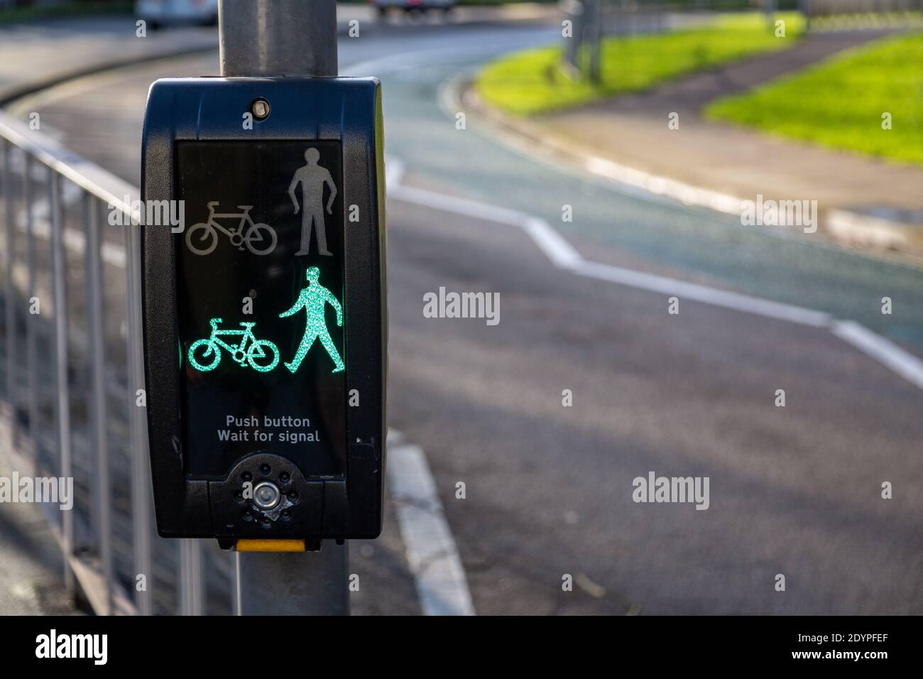 A green light on a pedestrian crossing button indicating that it is ...