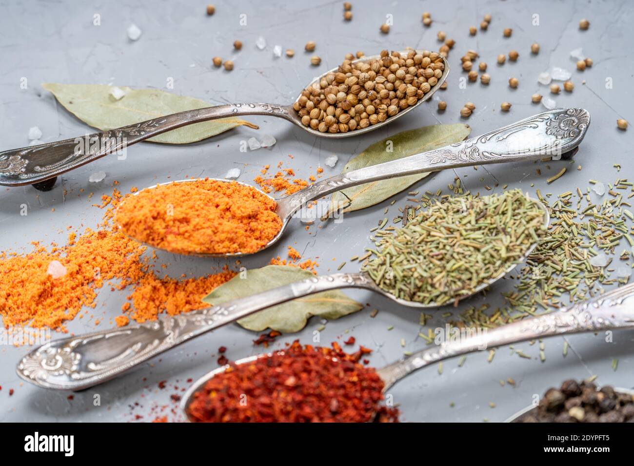 various spices in metal silver spoons with large crystals salt Stock ...