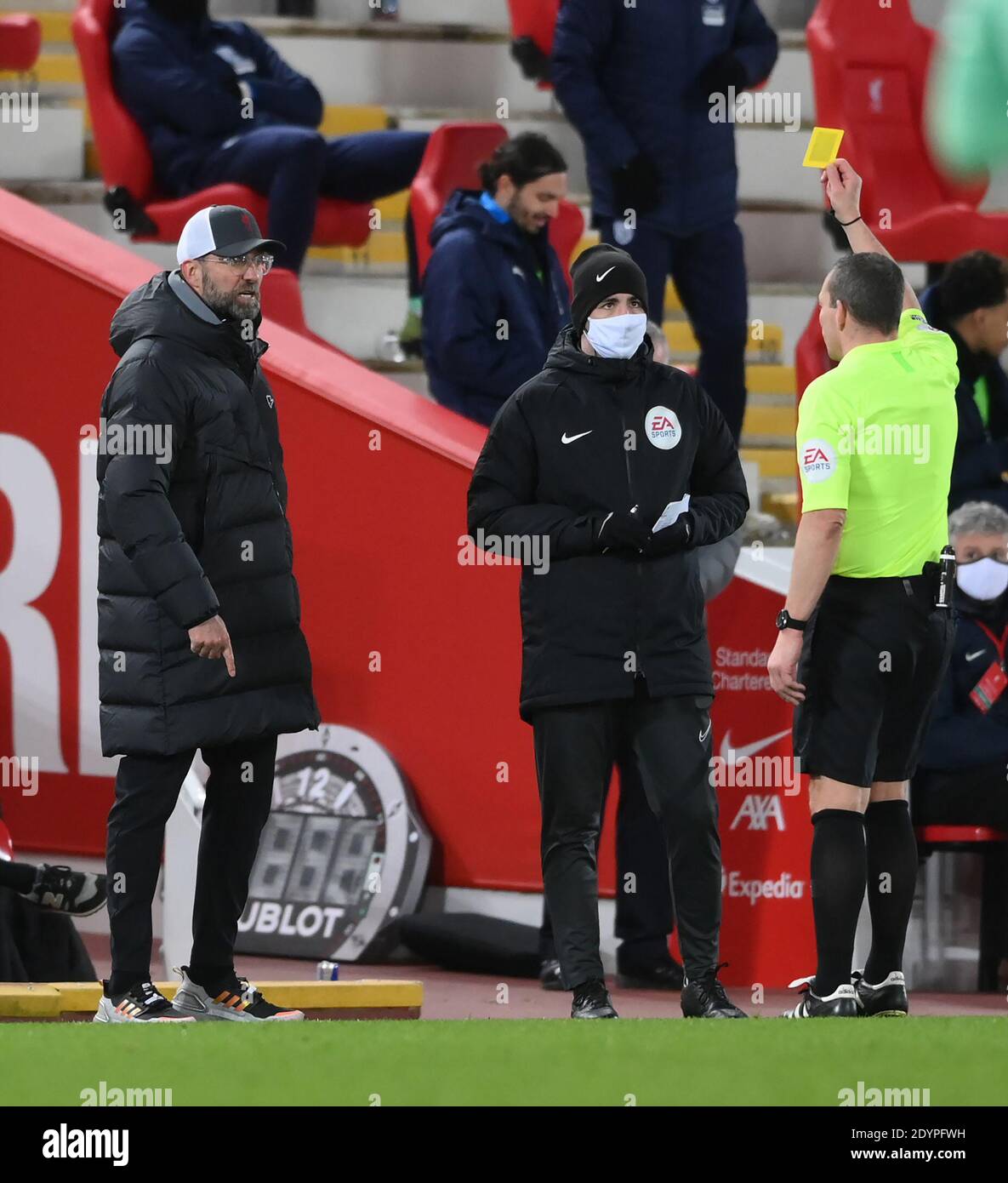 Liverpool manager Jurgen Klopp (left) is shown a yellow card by referee ...