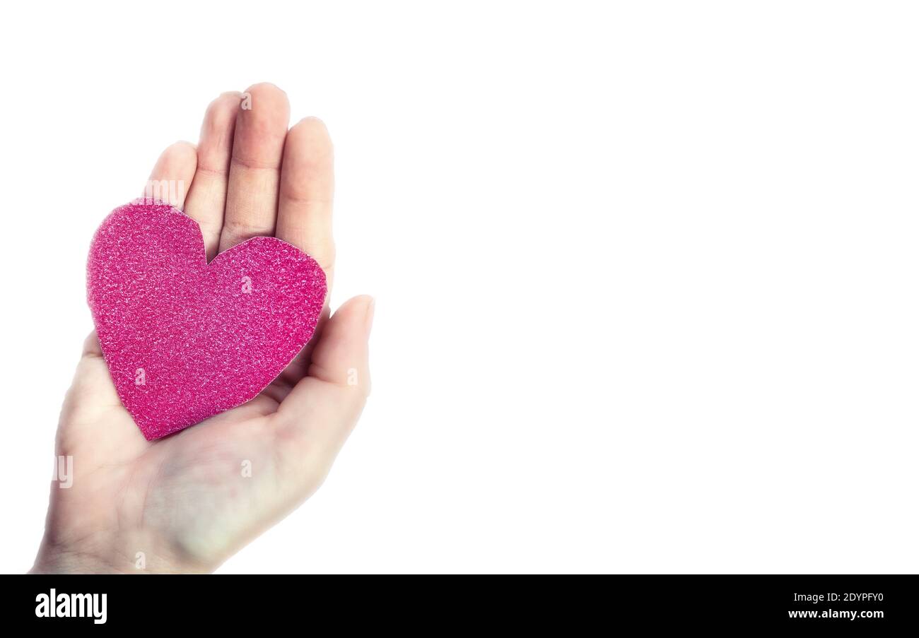 Female hand holding sparkling pink heart isolated on white background ...