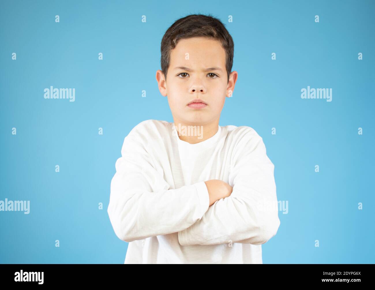 Beautiful caucasian bored boy pouting mouth and thinking with arm ...