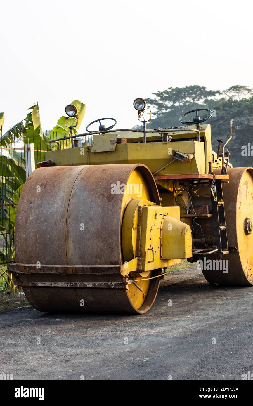 Old rusty yellow road roller on a newly constructed road Stock Photo ...