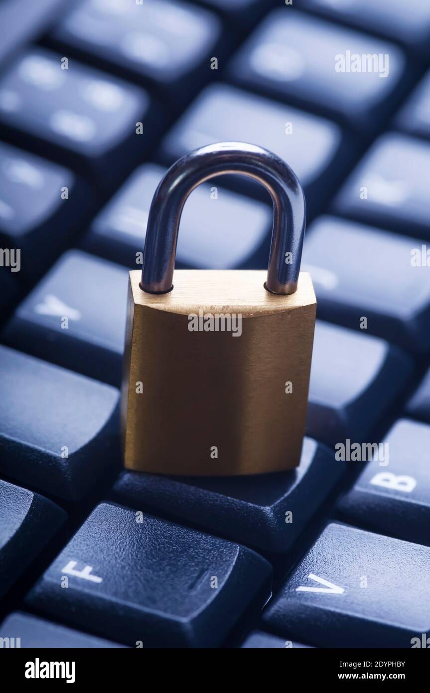 Locked metal padlock on blue computer keyboard. Data and password ...