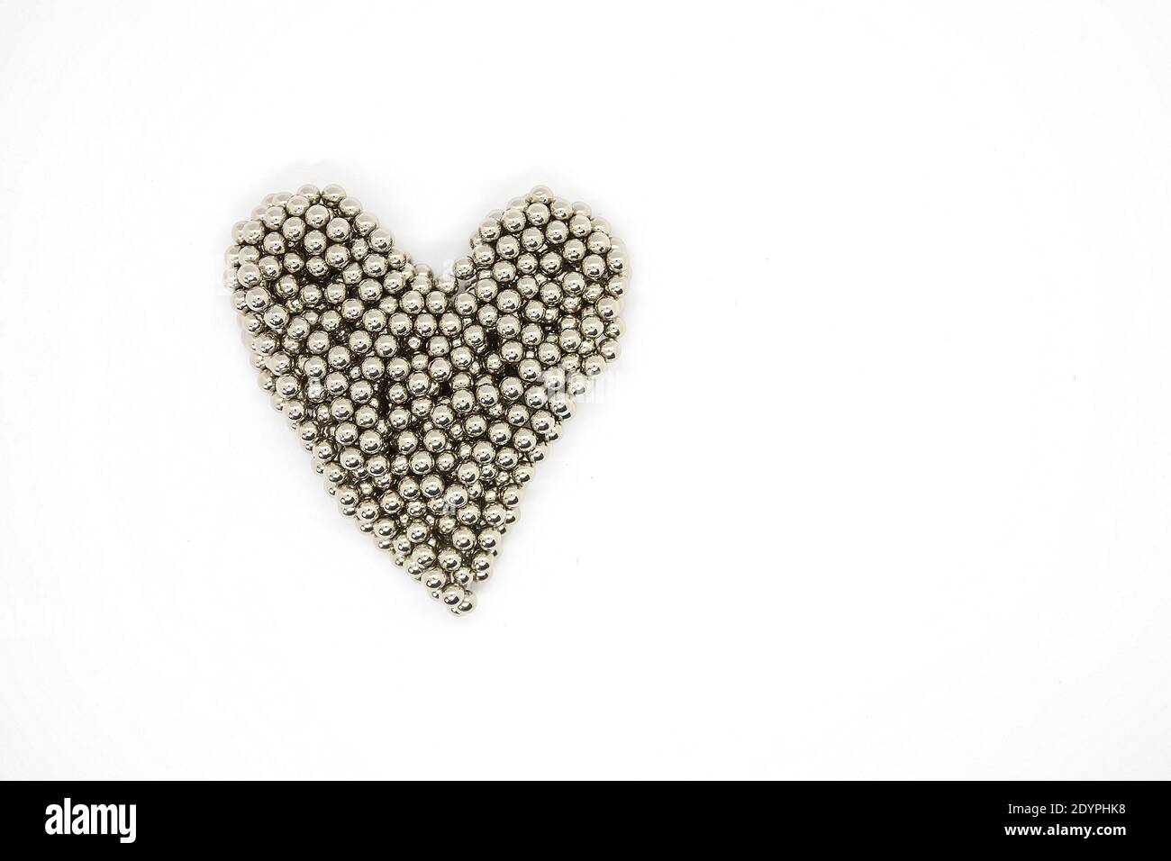 Heart shape made of metal sphere segments on white background Stock ...
