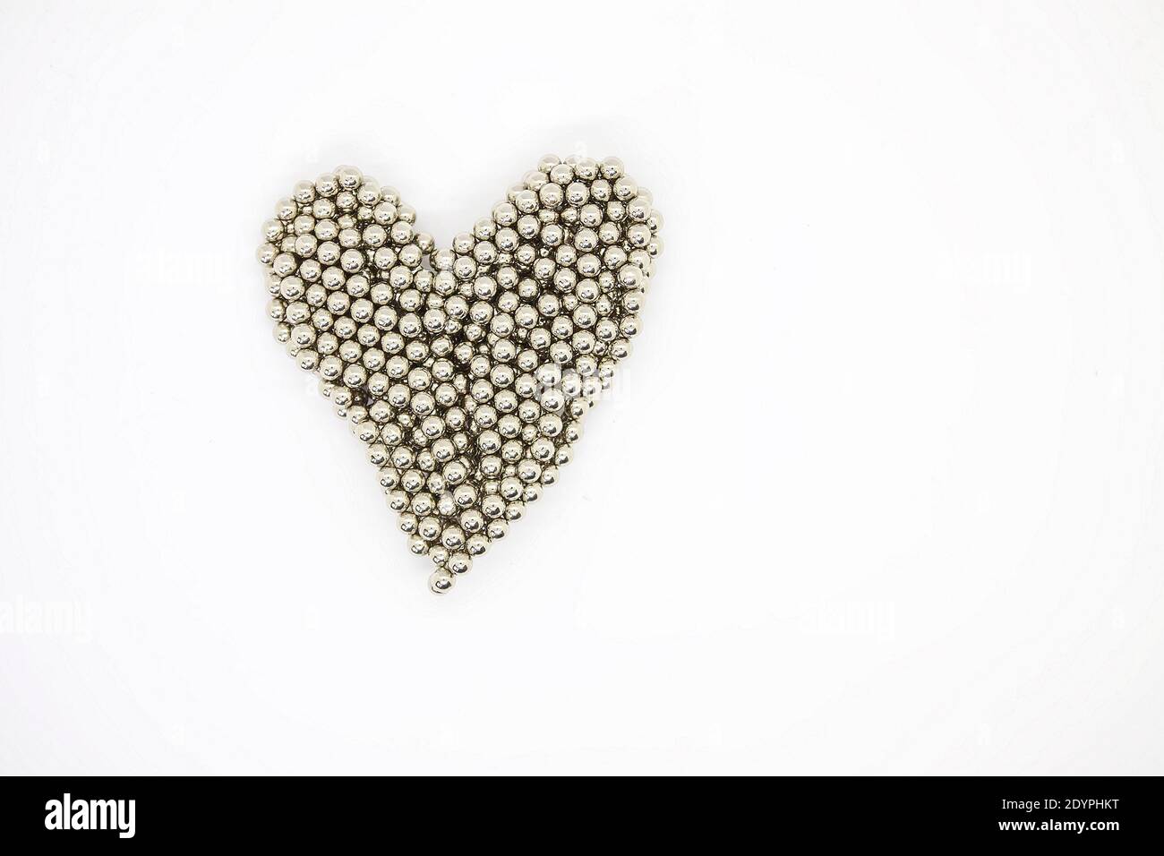 Heart shape made of metal sphere segments on white background Stock ...