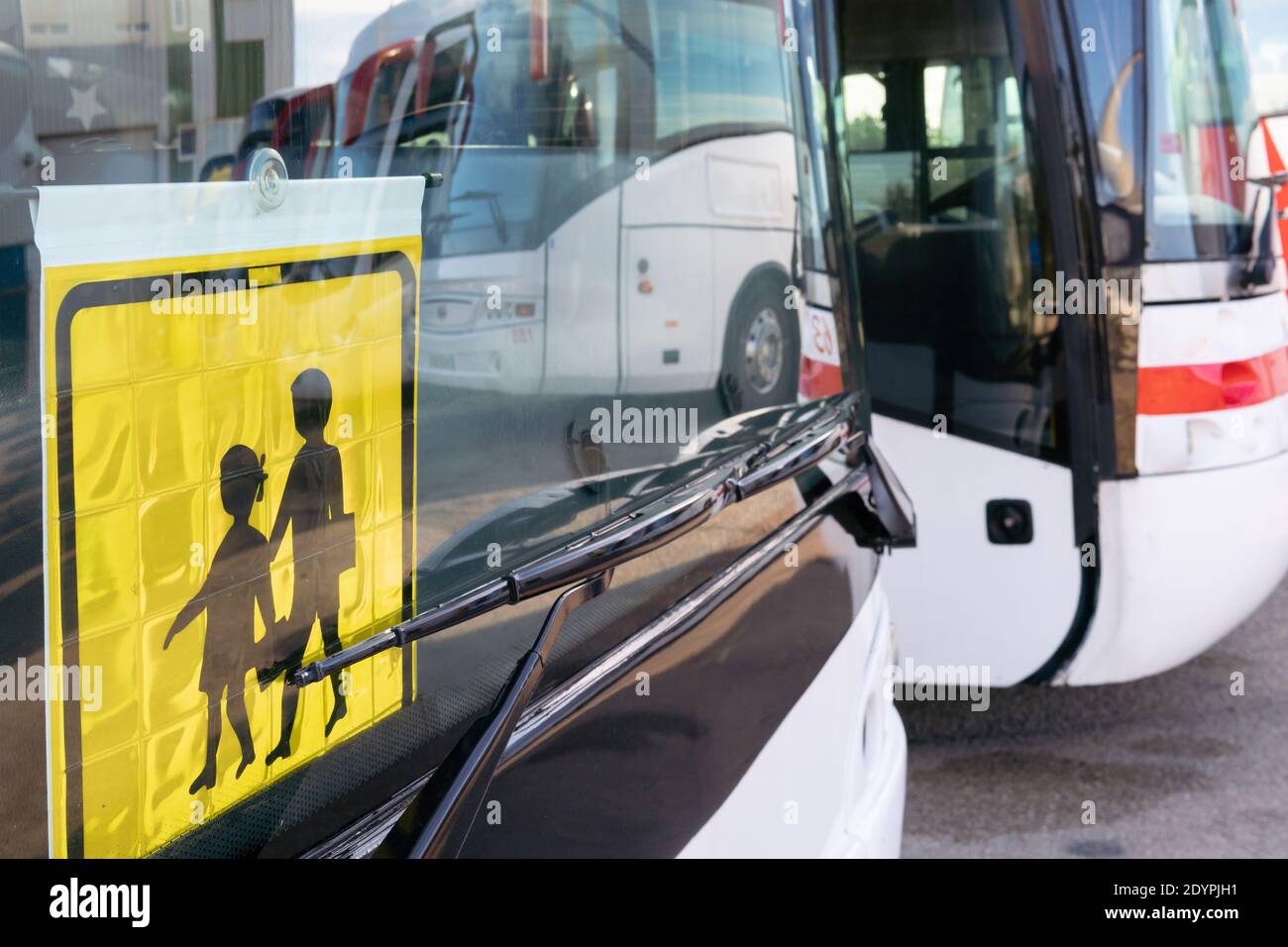 Close-up of school bus parked on a plot of land Stock Photo - Alamy