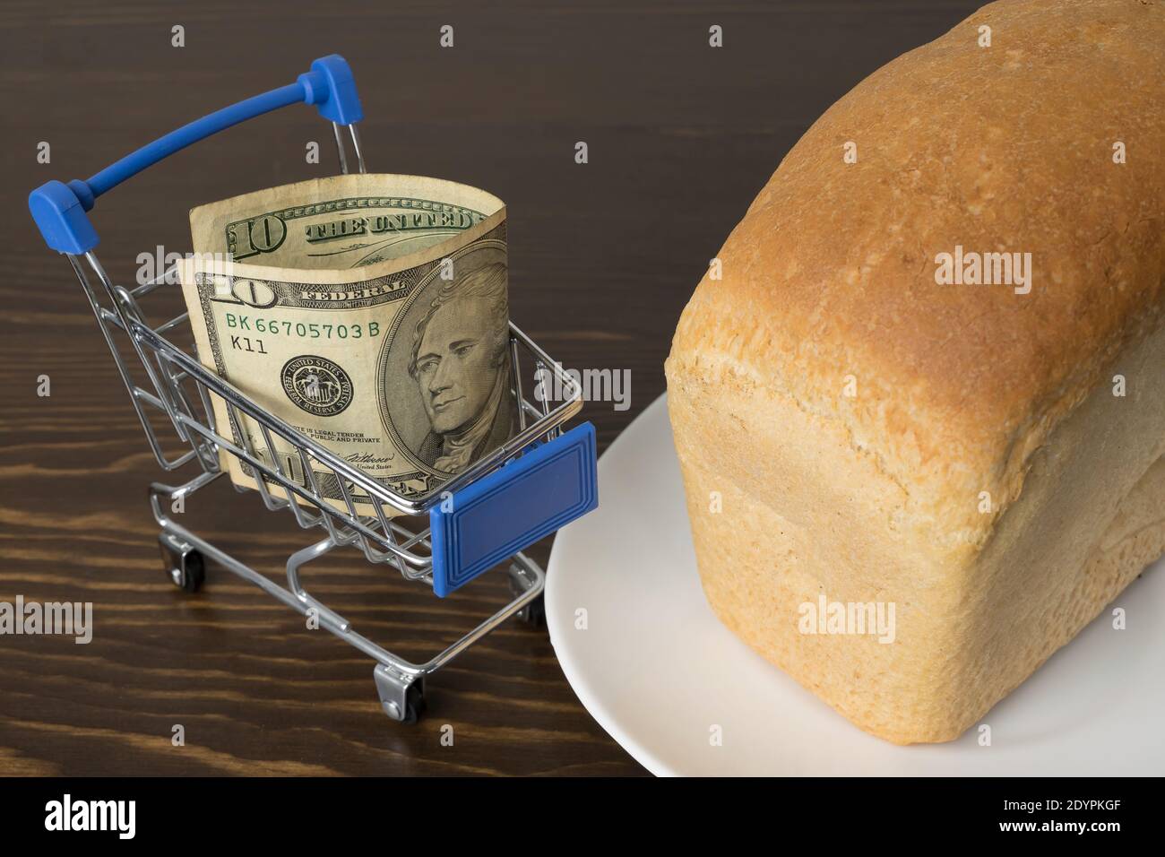 10 Dollars in a grocery basket with bread. Rising food prices and ...