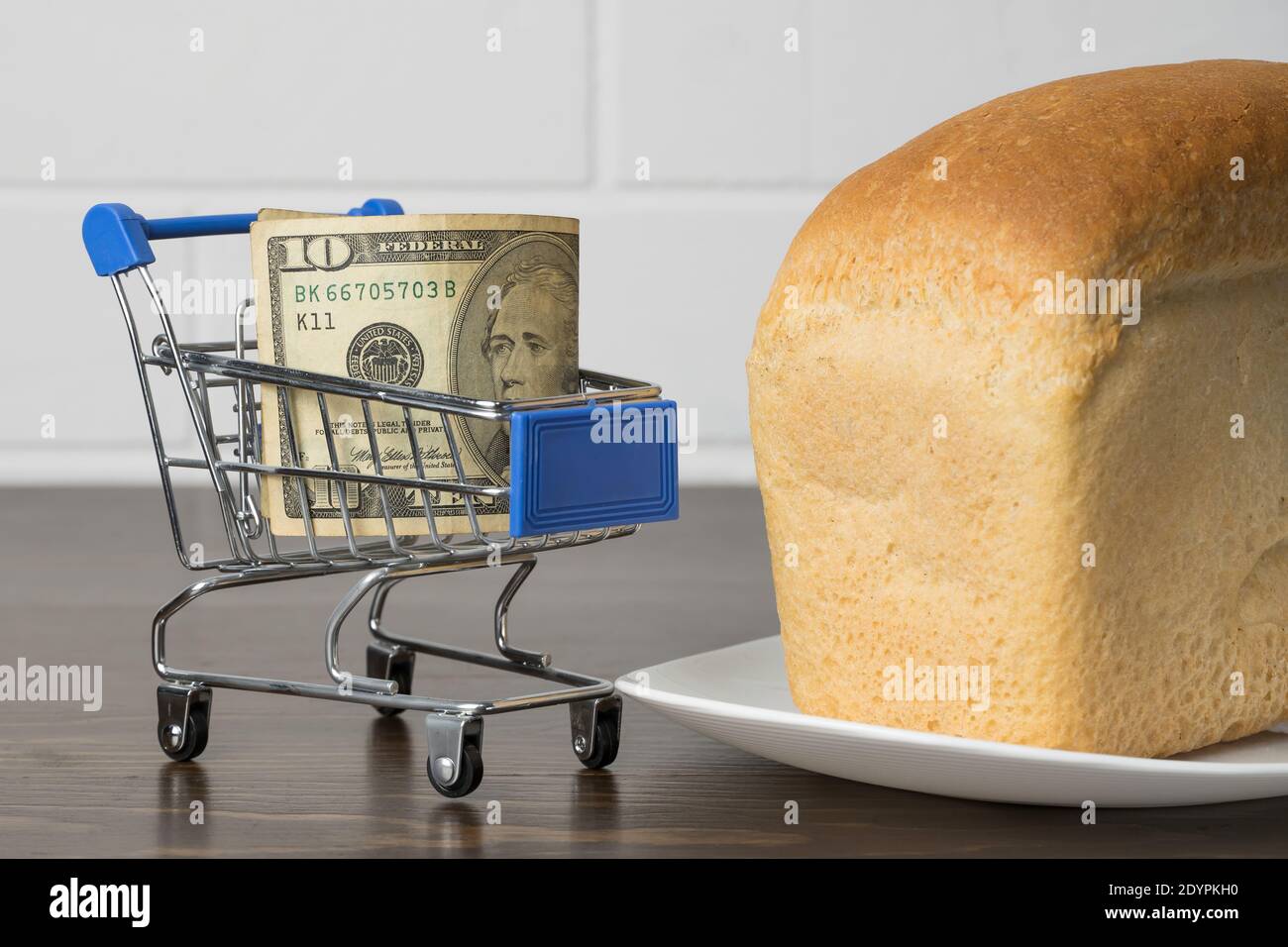 10 Dollars in a grocery basket with bread. Rising food prices and ...