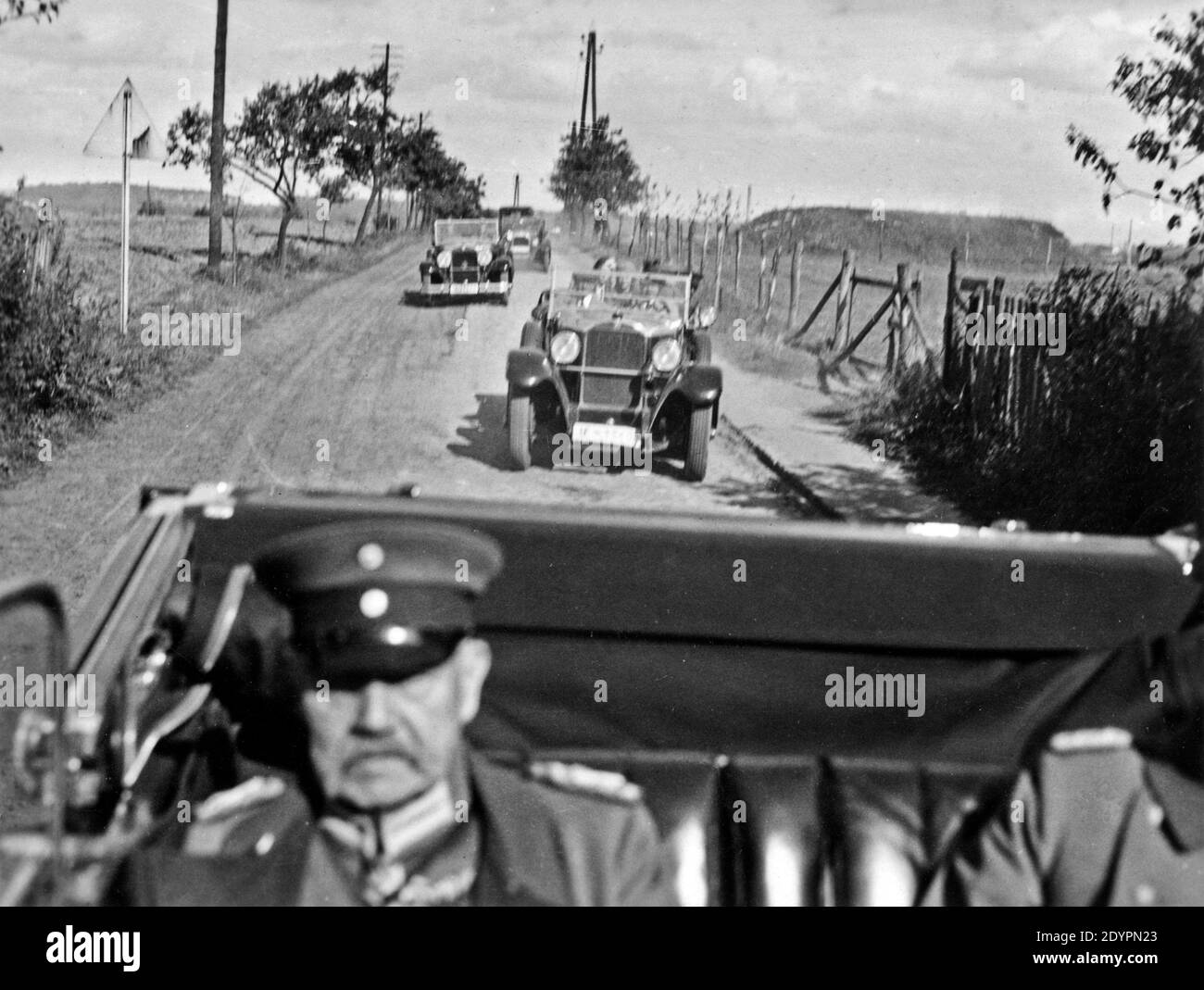 Paul von Hindenburg in his official car, followed by more cars, about ...