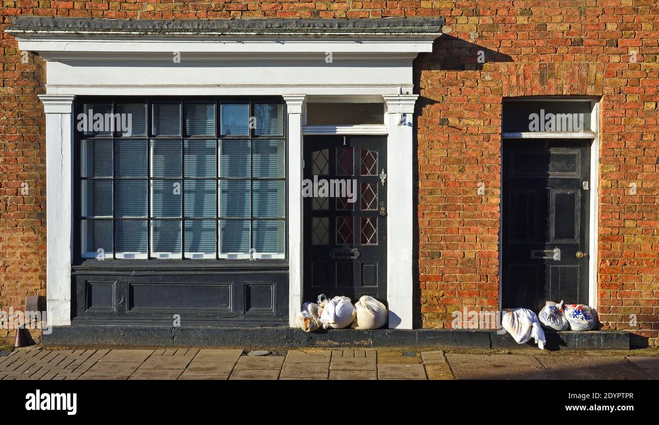 Old shop building with sandbags in doorways to prevent flooding Stock ...