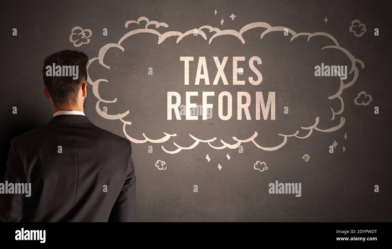 businessman drawing a cloud with TAXES REFORM inscription inside ...