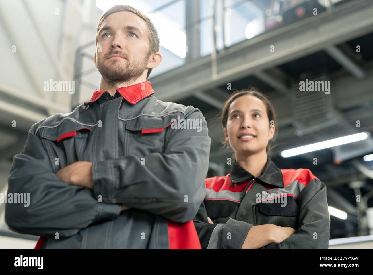Two men standing crossing arms hi-res stock photography and images - Alamy