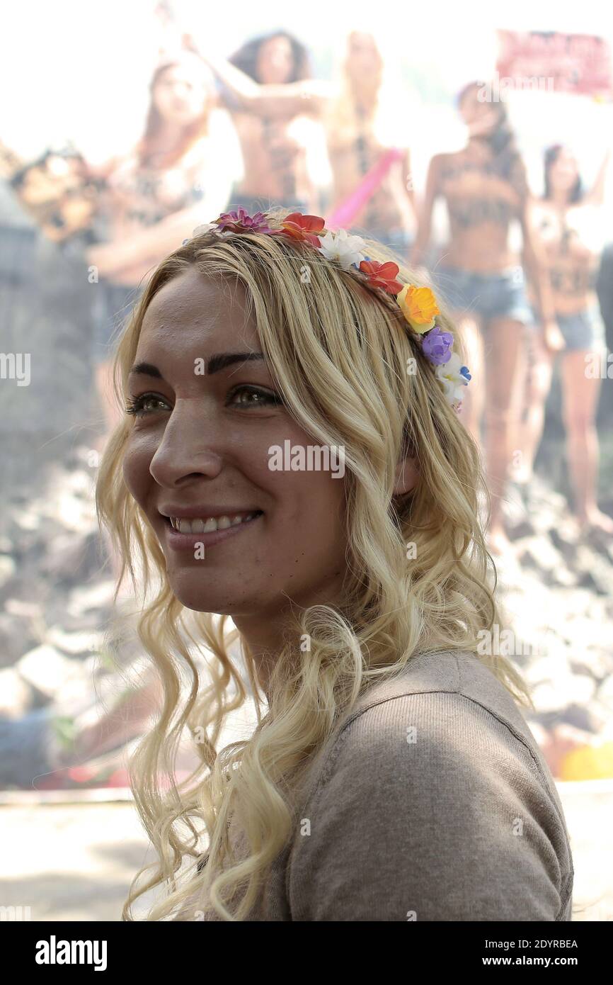 Leader of feminist organization Femen, Inna Shevchenko poses in front of a giant poster by ...
