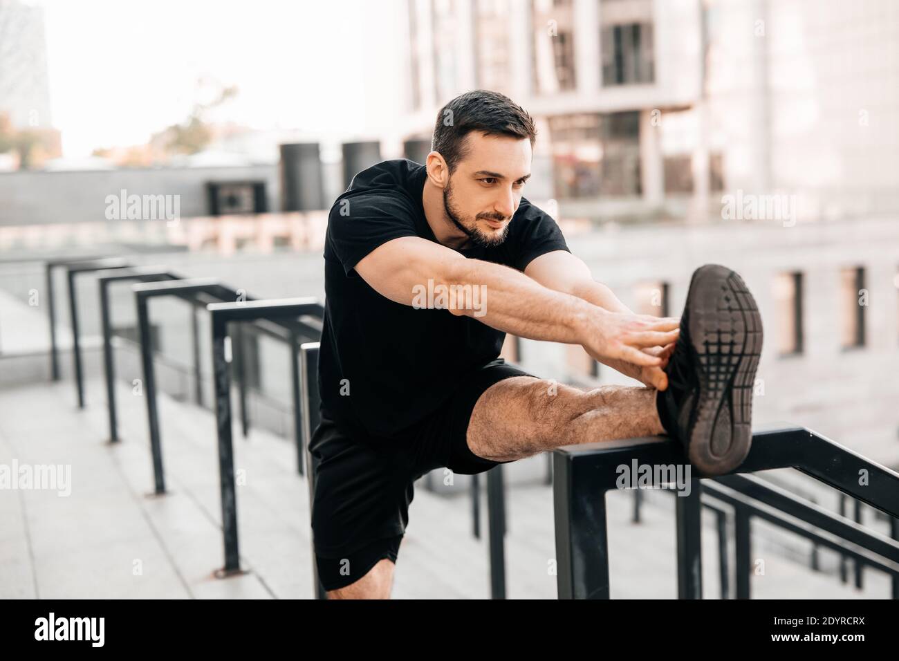 Man stretching back before morning activity. Sport in big city concept ...