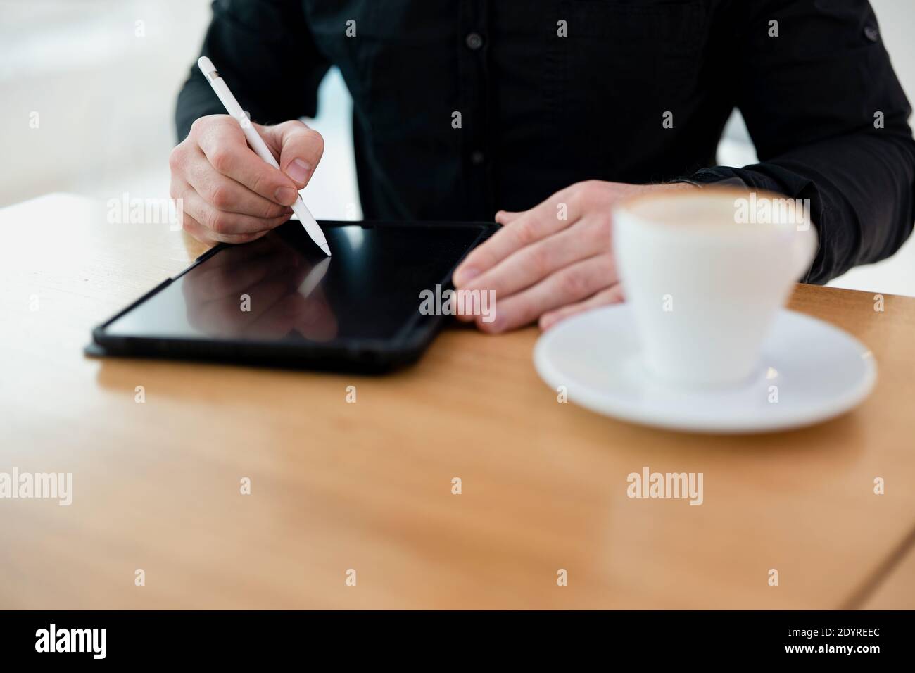 Man using his tablet with stylus. opy space screen on gadget. Cut close ...