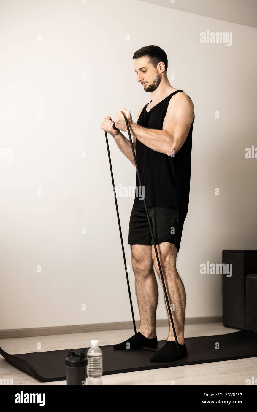Guy performs resistance band exercises hi-res stock photography and ...