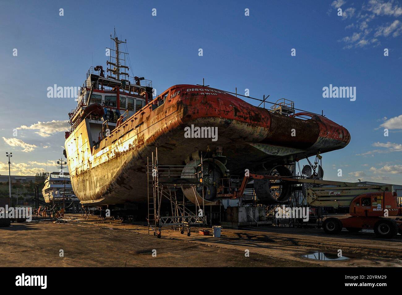 A rear view at sunset of a maritime tug boat on the slipway undergoing ...