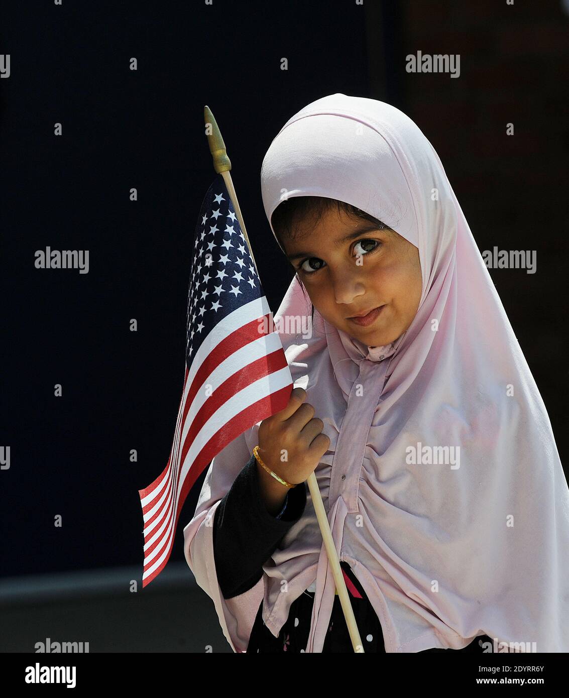 Fatima Zia holds an American flag given by his father who was one of ...