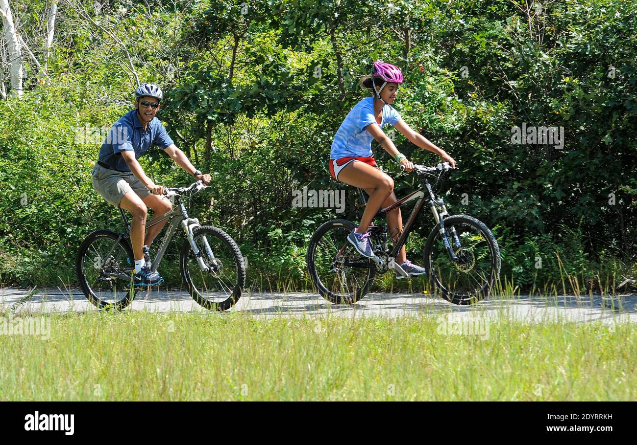 President Barack Obama bike riding with his daughter Malia during their ...