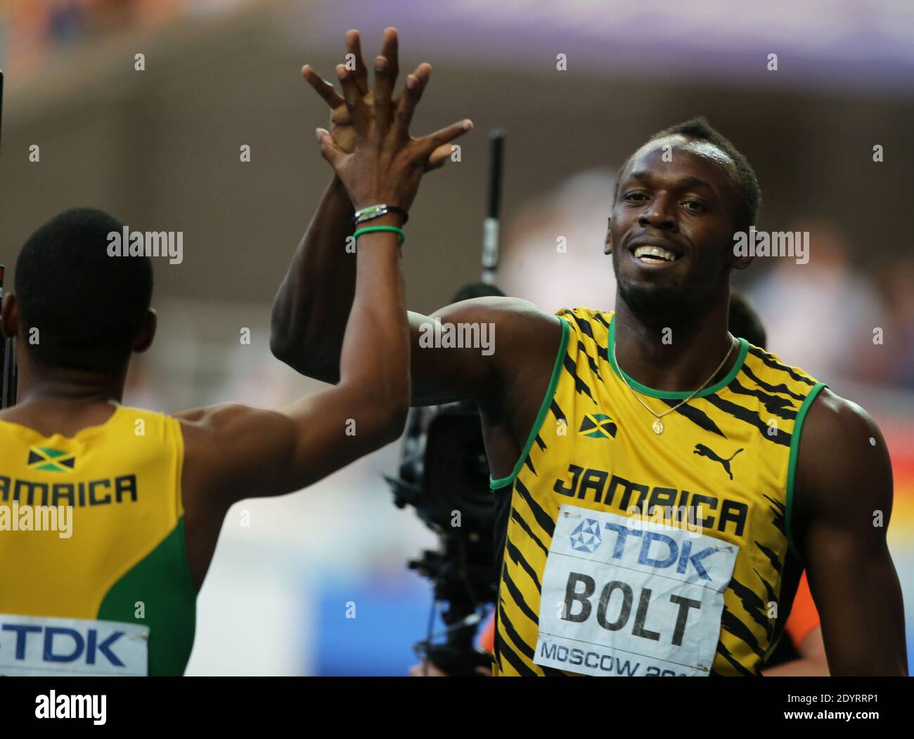 Usain Bolt (R) of Jamaica shakes hands with his compatriot Warren Weir ...