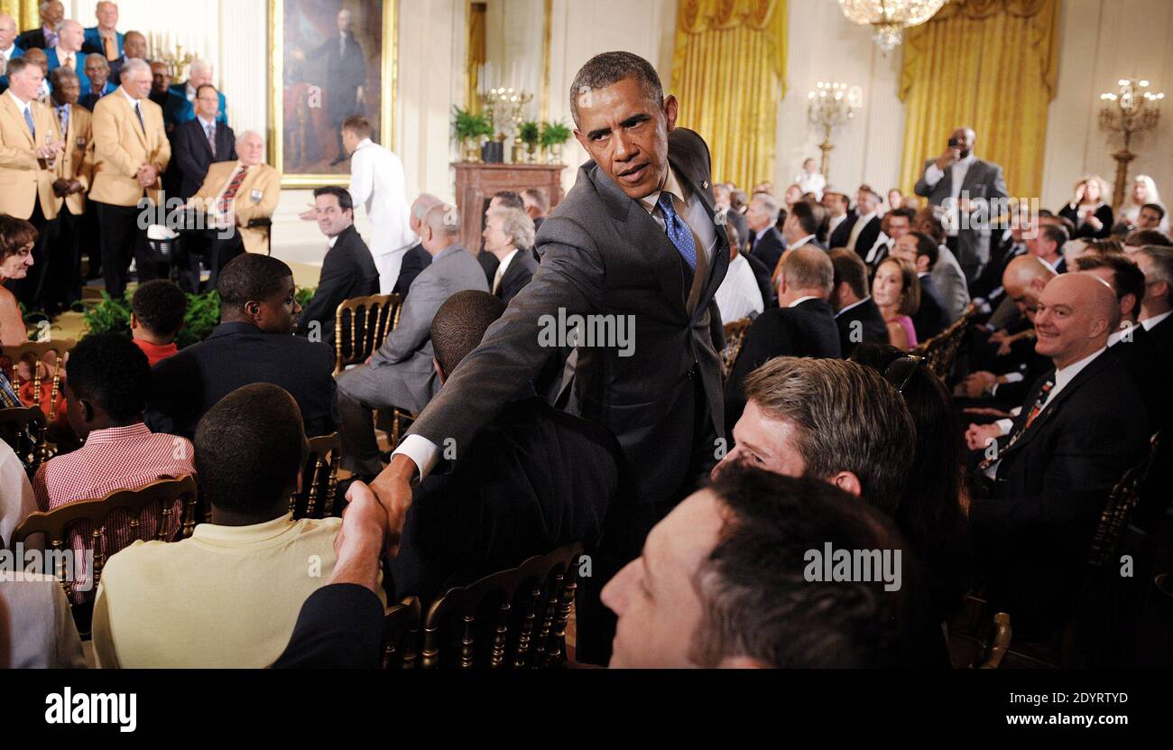 U.S. President Barack Obama checks hands with guests after welcoming ...