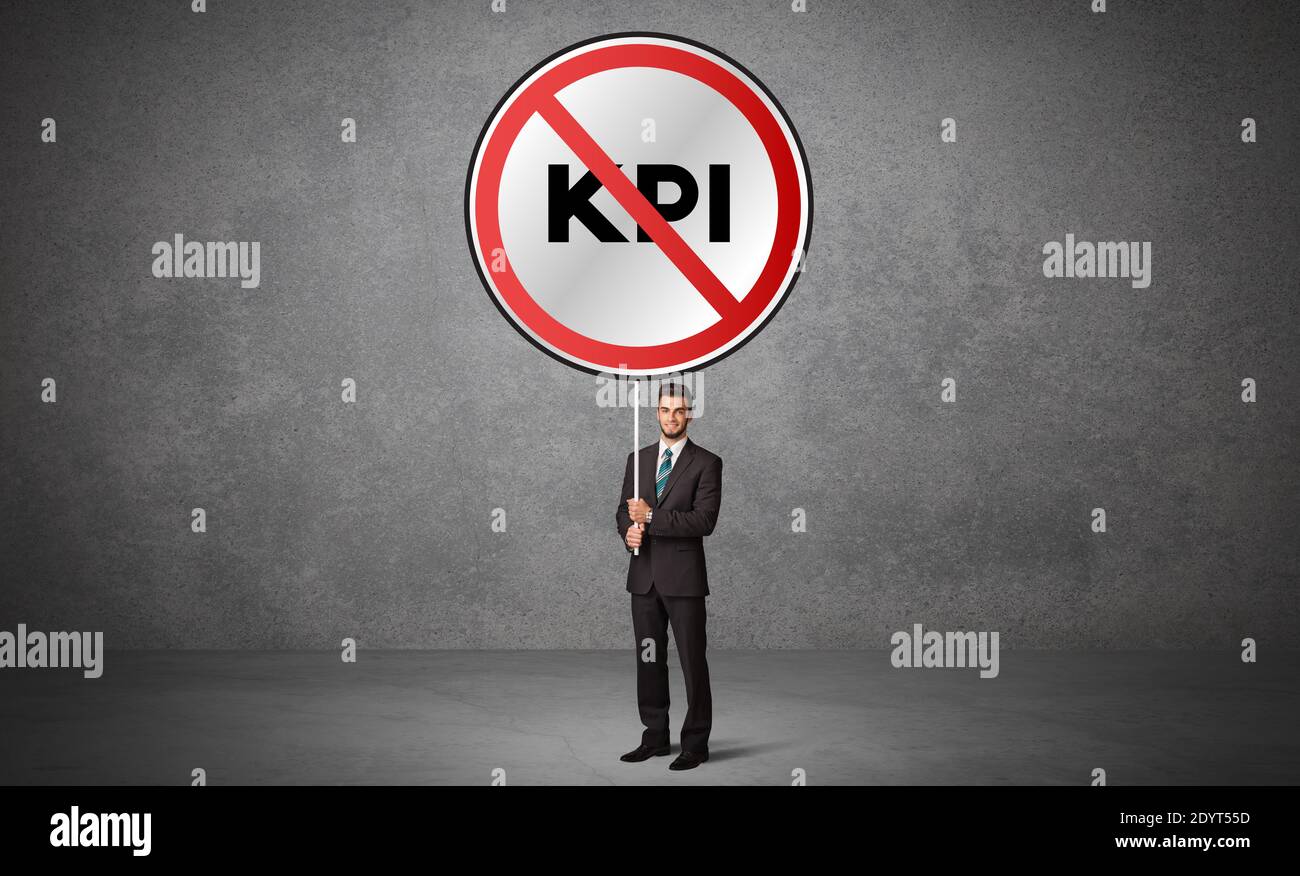 Young business person holdig traffic sign with KPI abbreviation ...