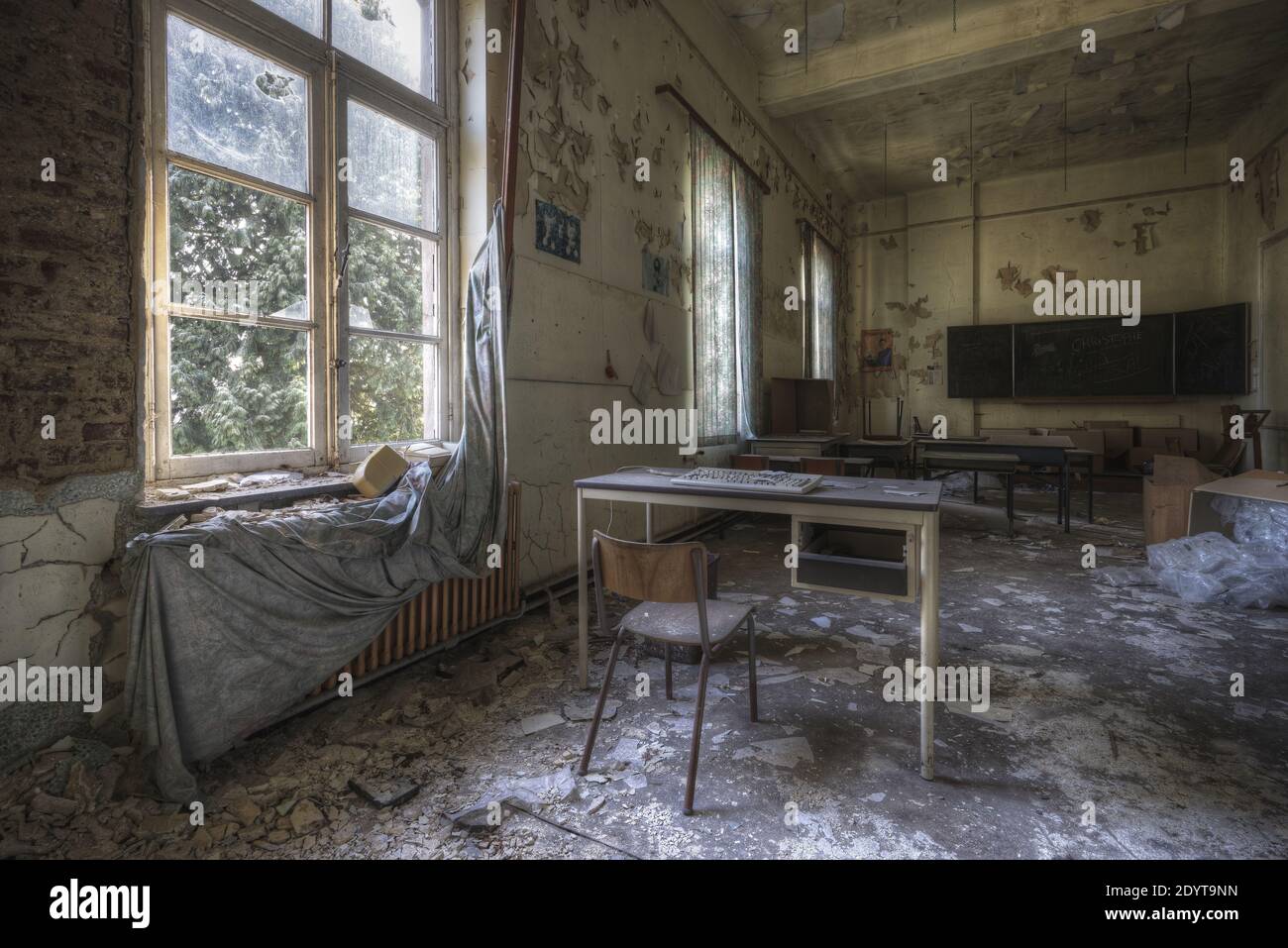 A ruined classroom with broken windows and walls of an abandoned school ...