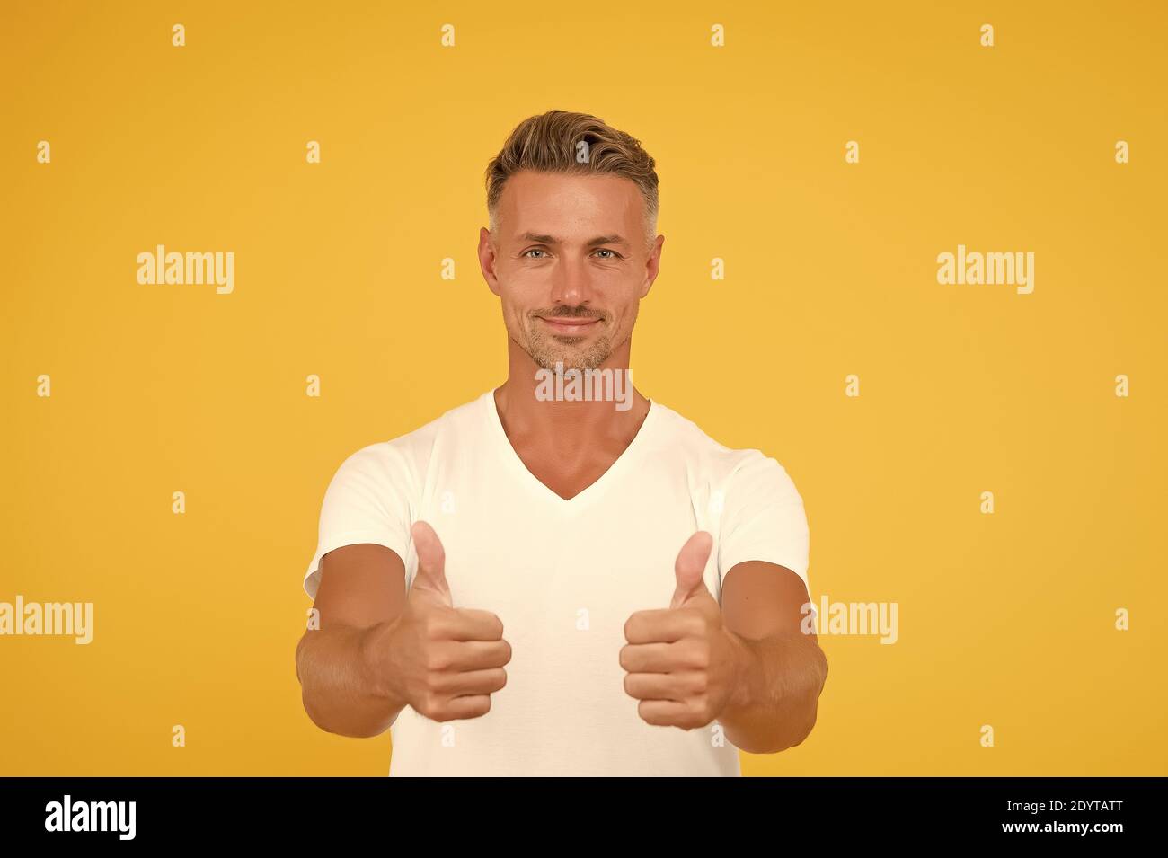 Visual advertising. Happy guy show thumbs ups. Advertising agent yellow ...