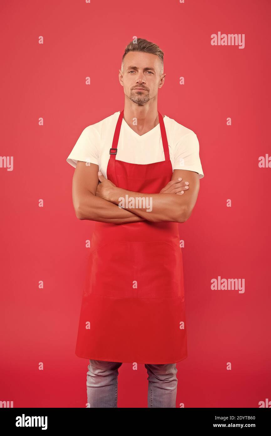 handsome waiter in red apron. Successful small business owner. serious ...