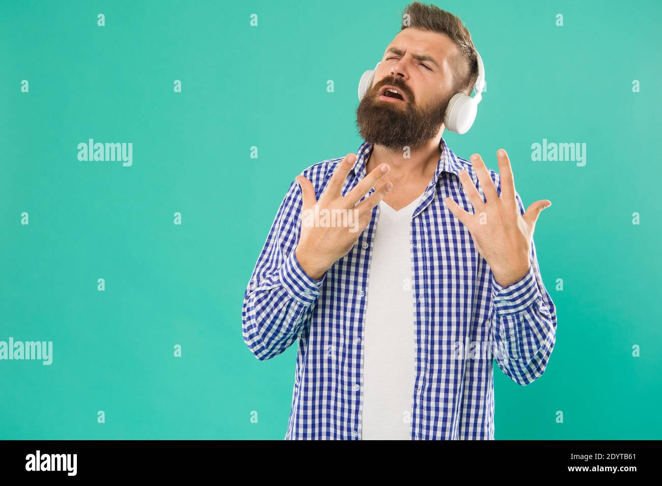 inspired caucasian guy with beard and mustache enjoy music in digital ...