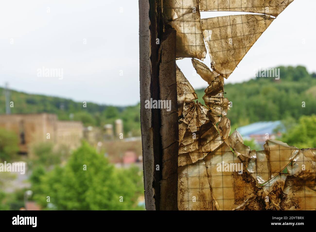 looking outside a dirty broken industrial window at landscape Stock ...