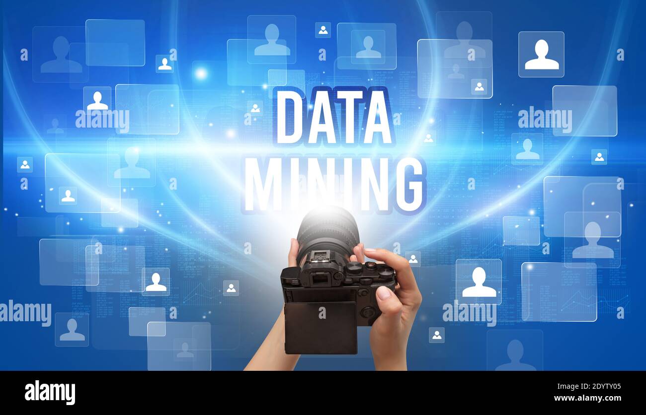 Close-up of hand holding camera with DATA MINING inscription, video ...
