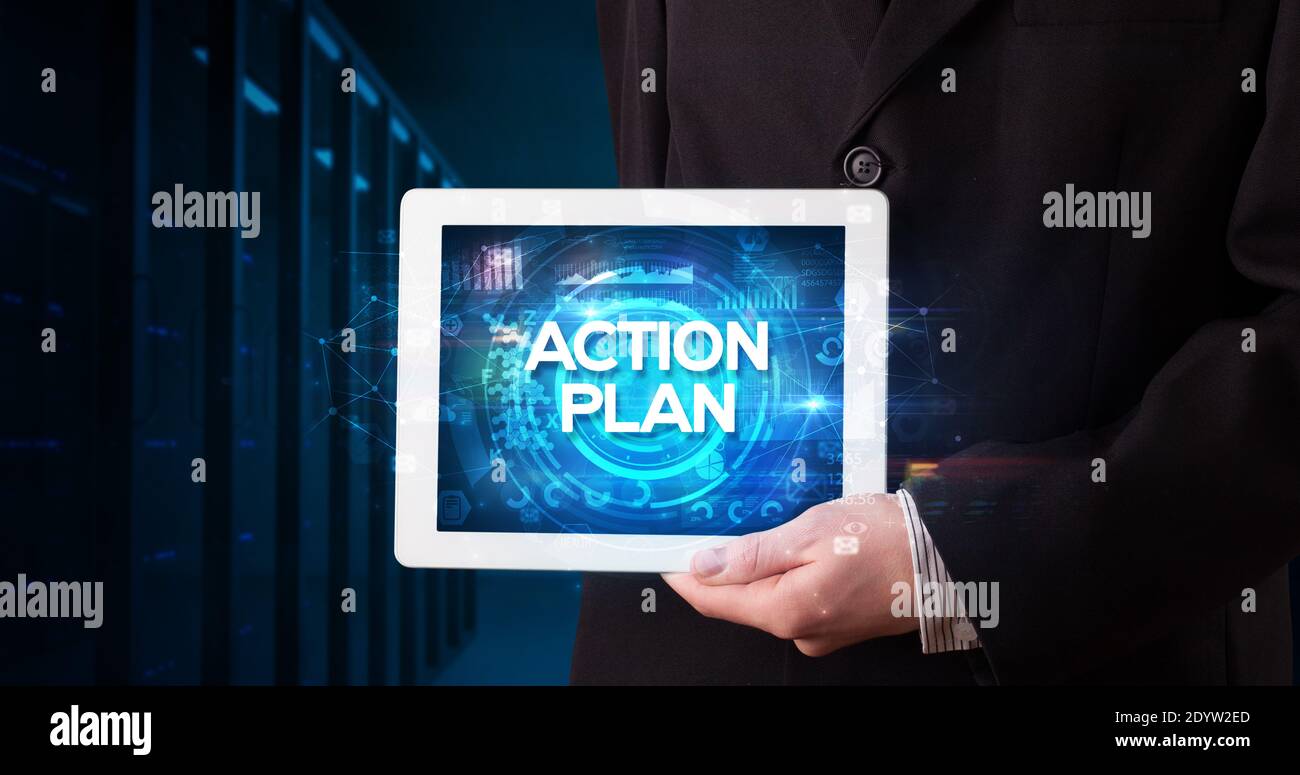 Young business person working on tablet and shows the inscription ...