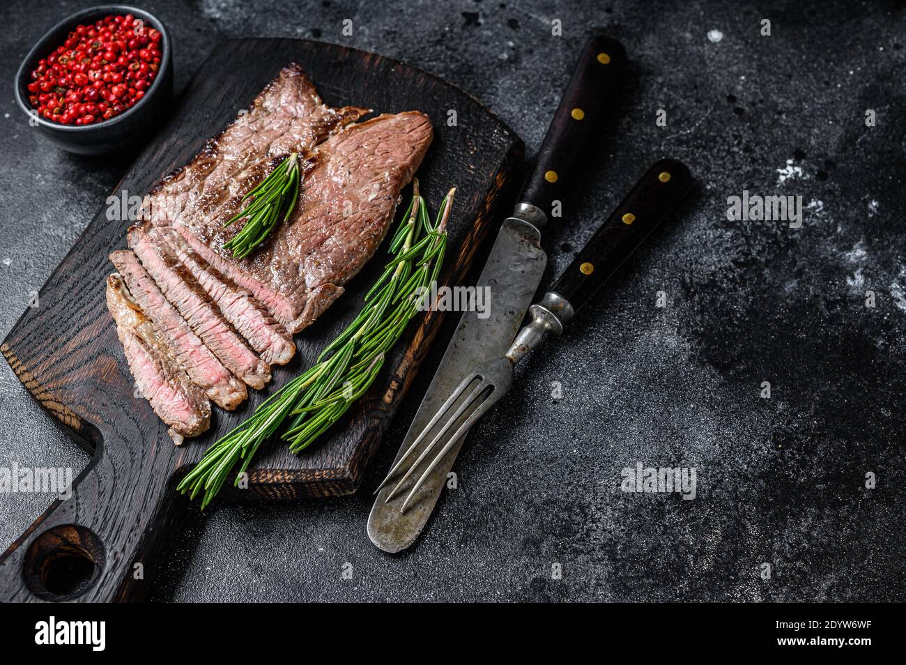 Grilled beef meat chop round steak on a cutting board. Black background ...