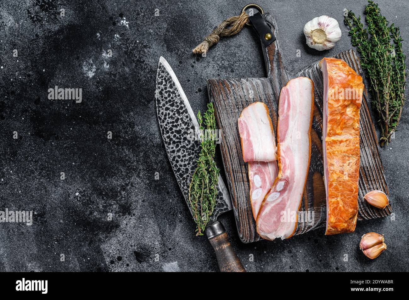 Smoked pork belly bacon block. Black background. Top view. Copy space ...