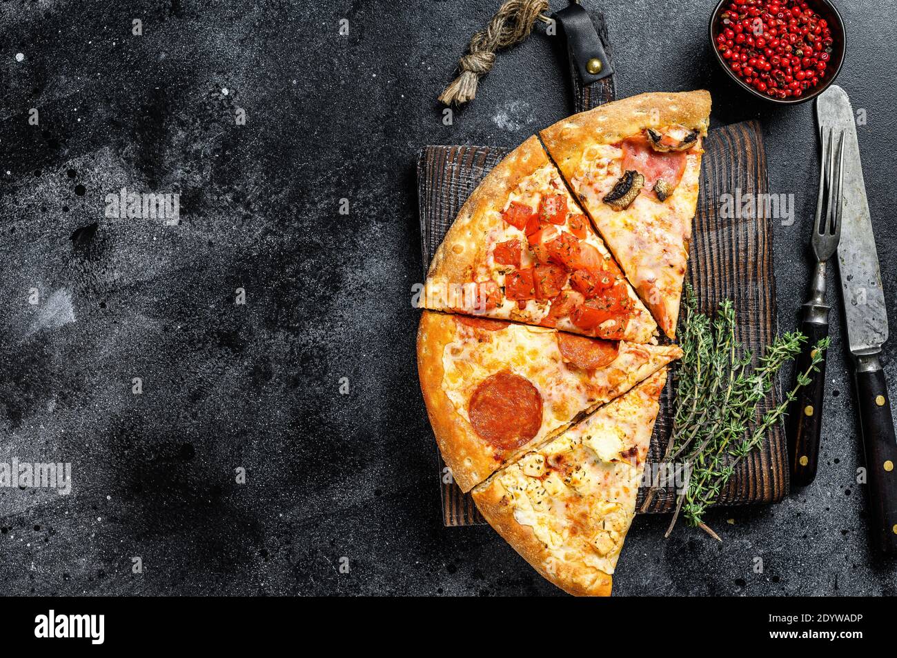 Set of Different slices of pizza. Black background. Top view. Copy ...
