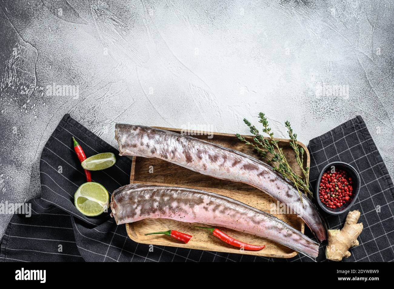 Raw king klip, congrio fish with cooking ingredients. gray background ...