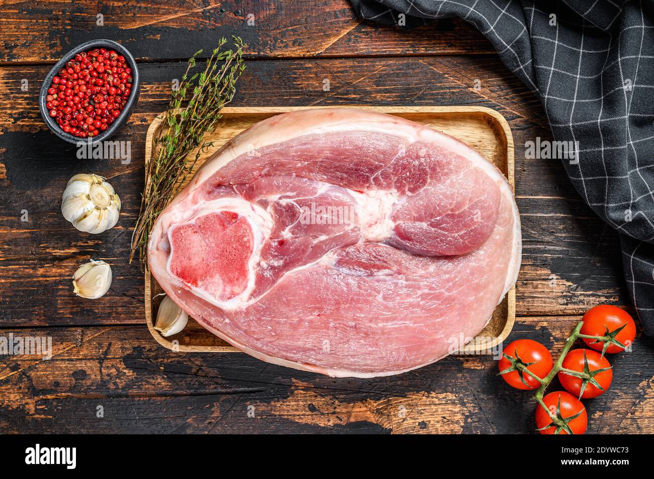 Cut of raw pork knuckle, leg on a cutting board. Farm fresh meat ...