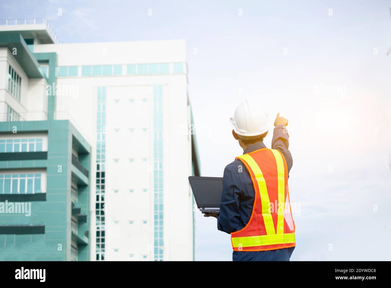 Engineering holding hand success and wears a white safety hat while ...