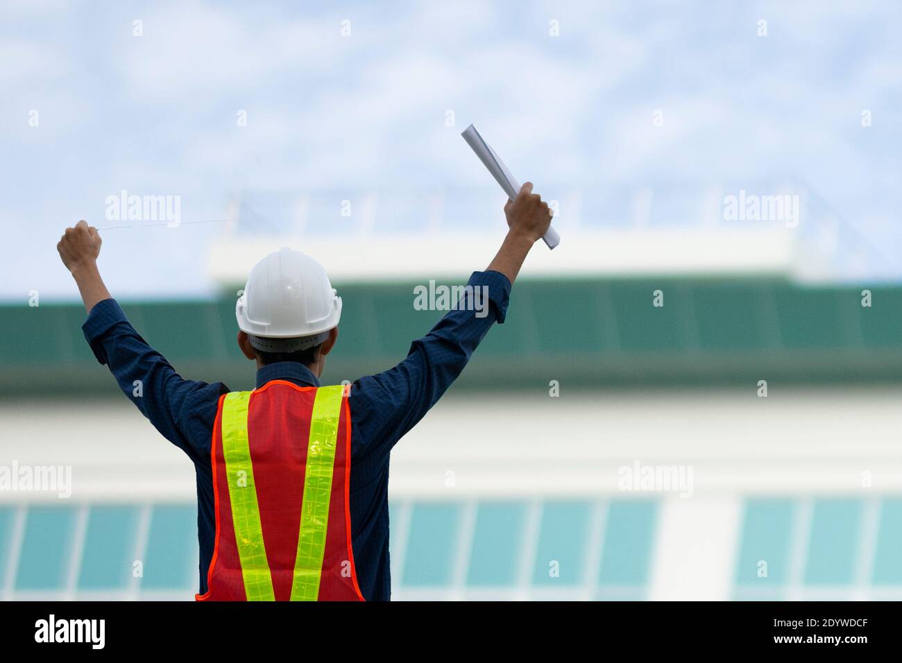 Engineering holding hand success and wears a white safety hat while ...
