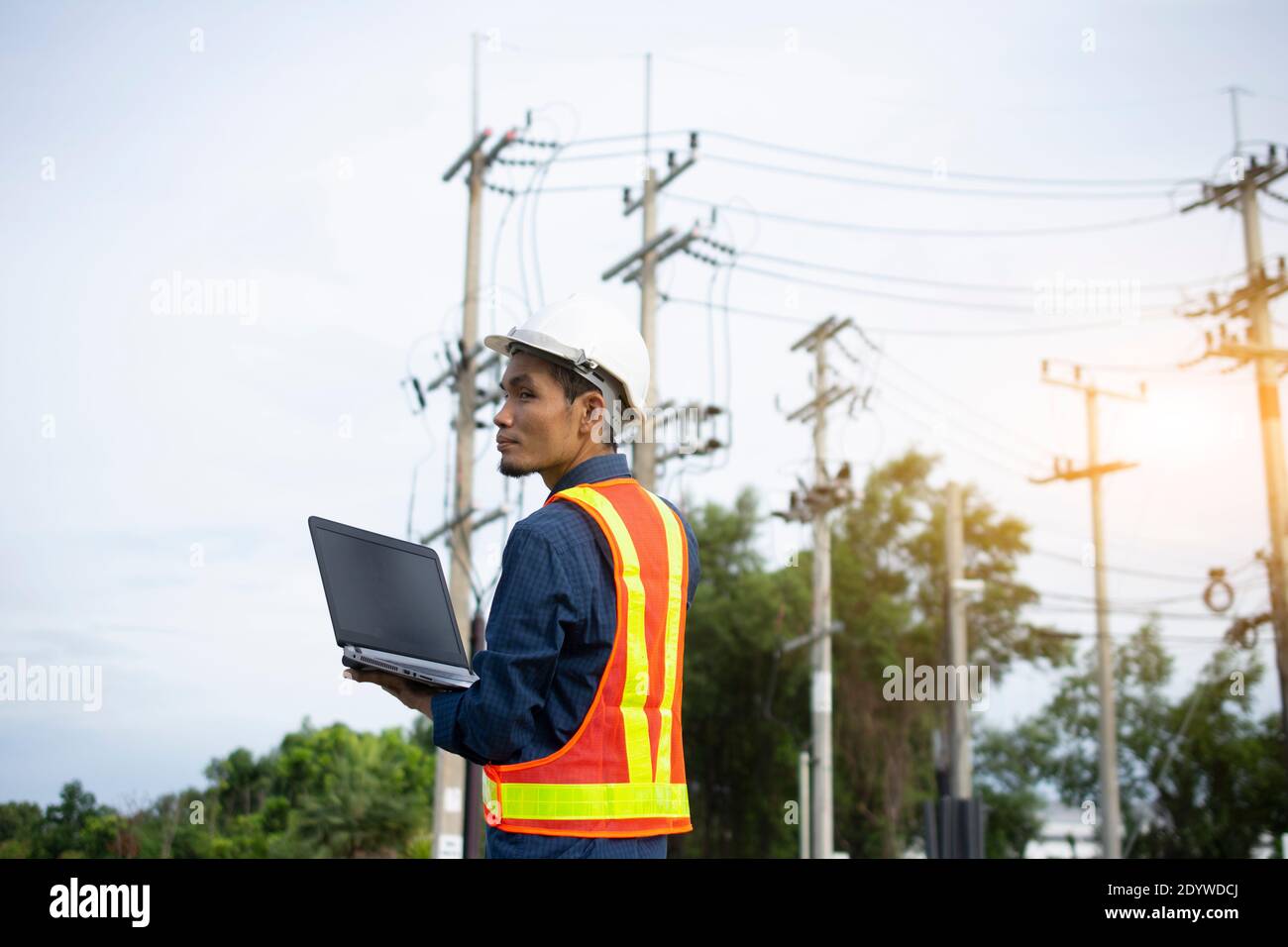 Engineering Holding Notebook inspects the wires on the electrical pole ...