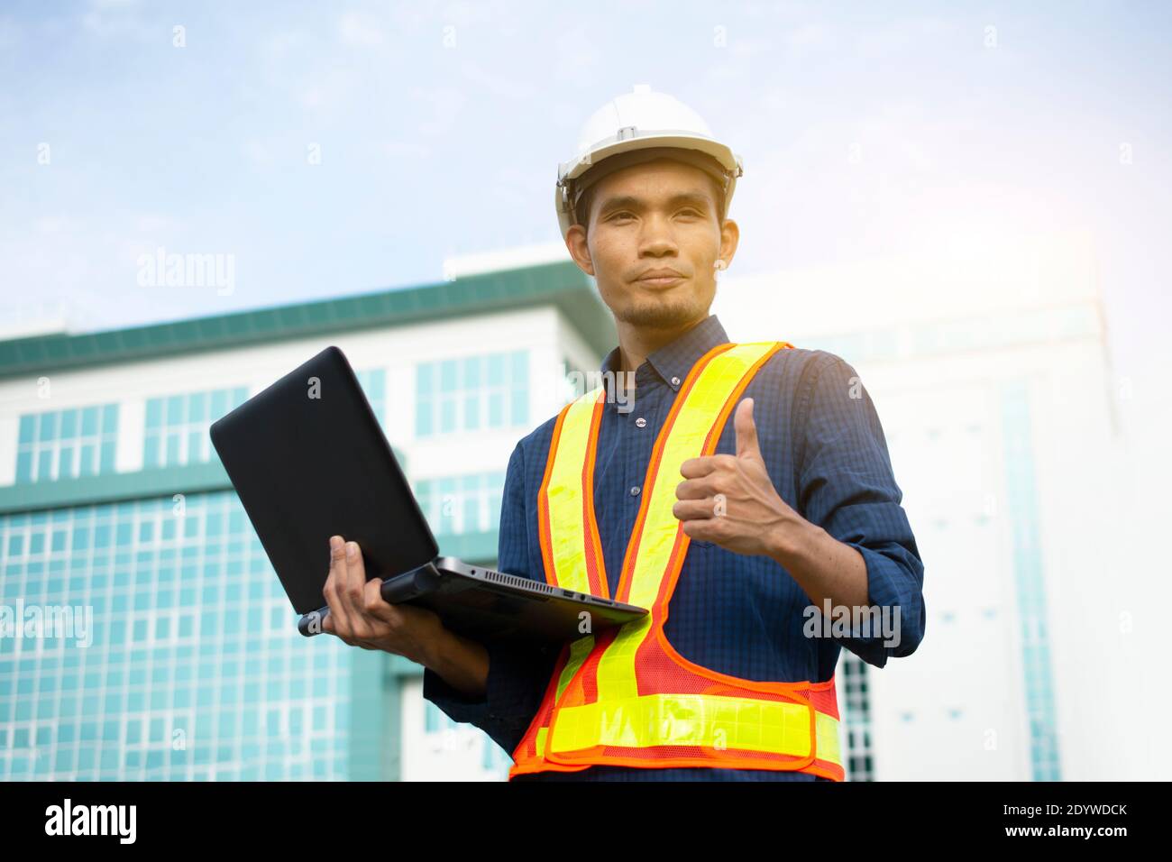 Engineer holding Computer Notebook for work and Sky technology ...