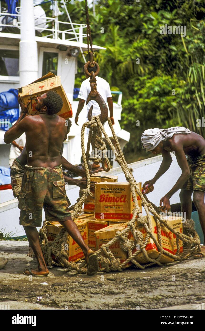 Papuan stevedores raise a sweat at the river port of Pomako, south of ...