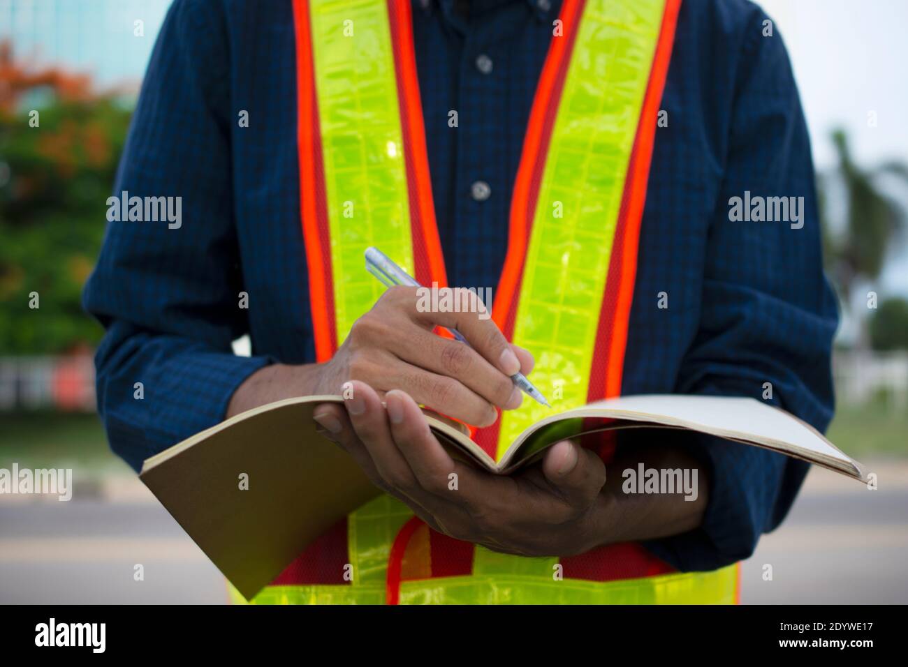 Engineer write take note on book for planing work Stock Photo - Alamy