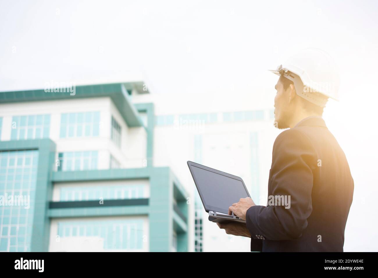 Engineer holding computer and working technology Stock Photo - Alamy
