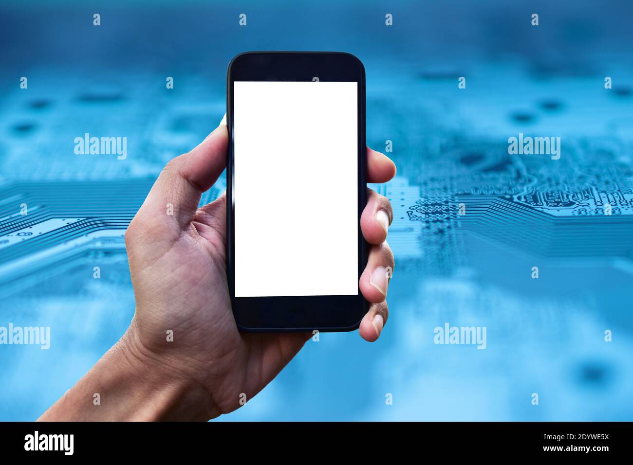 Hand holding Mobile Smart phone on PCB circuit background Technology ...