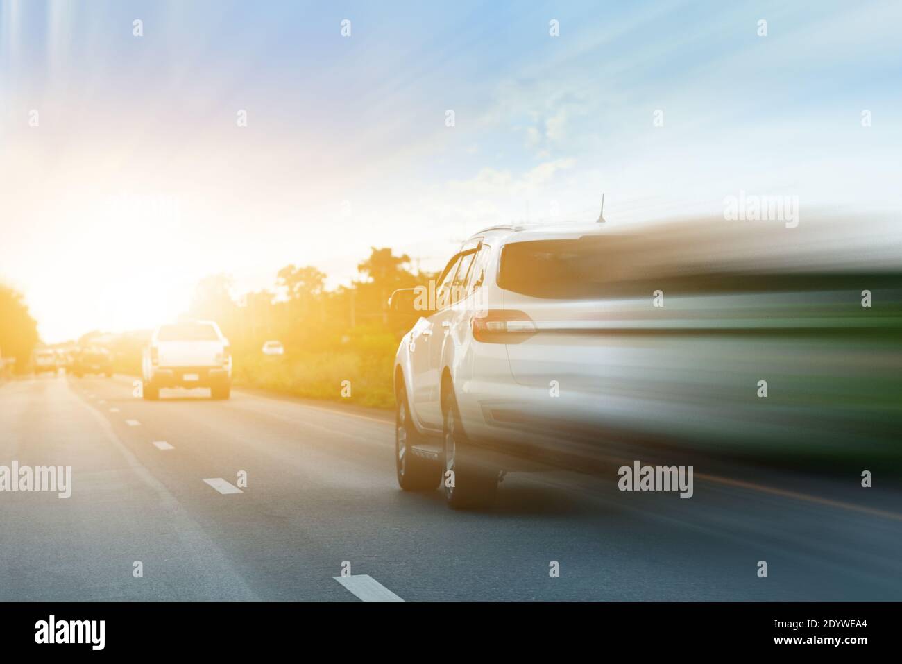 4WD car driving fast on highway road Stock Photo - Alamy