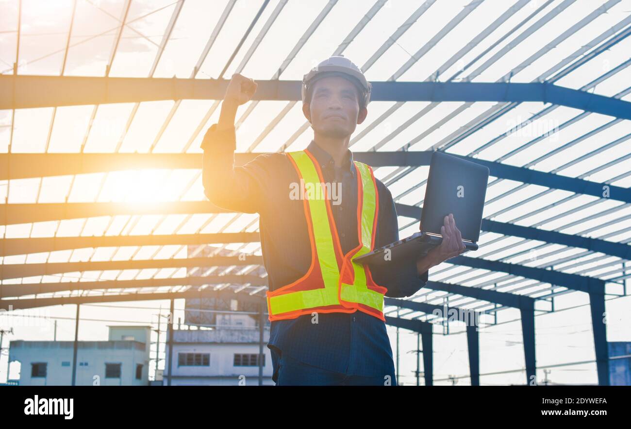 Engineer holding computer working on side technology Building ...
