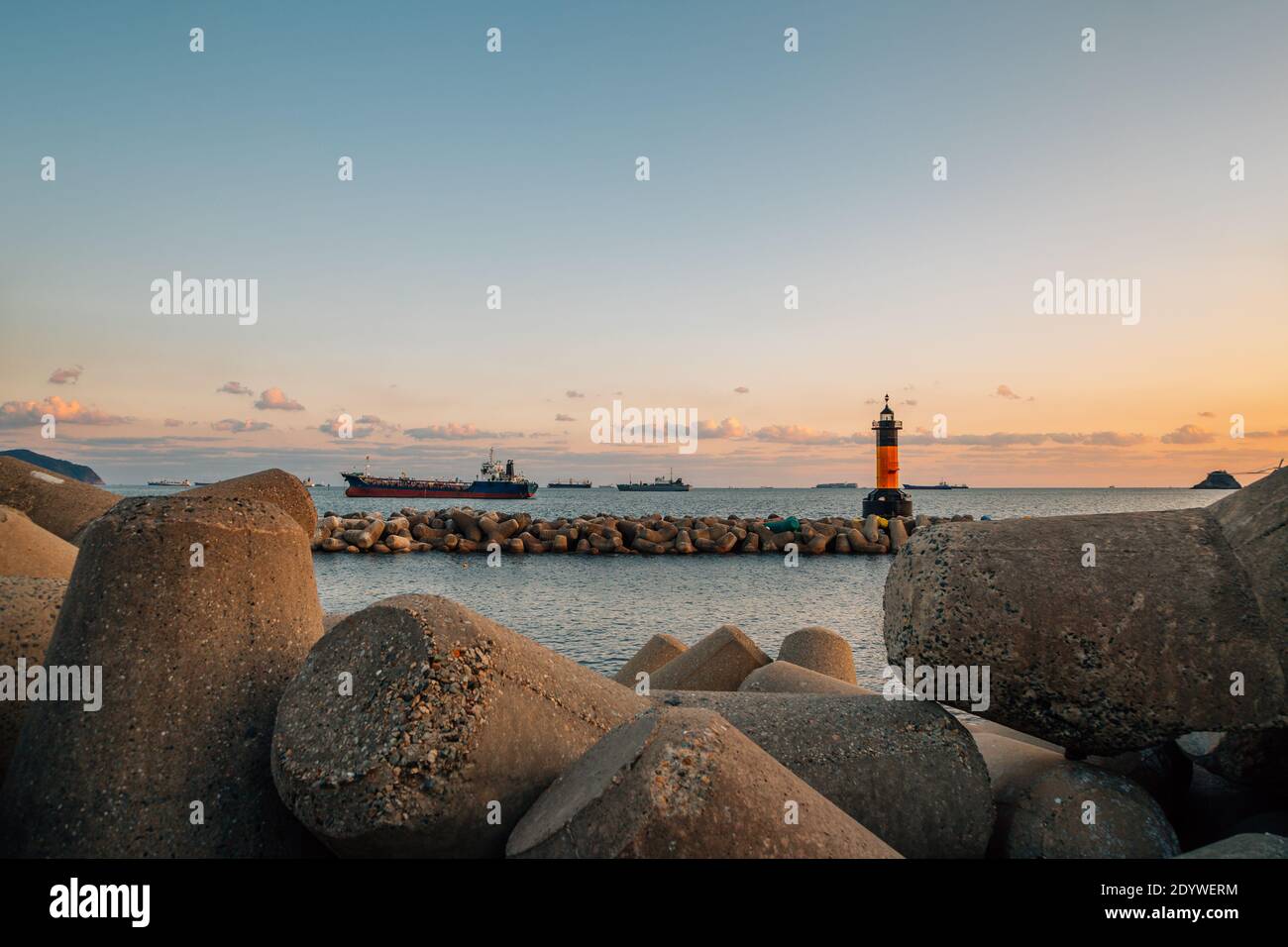 Sunset of Songdo beach, lighthouse and breakwater in Busan, Korea Stock ...