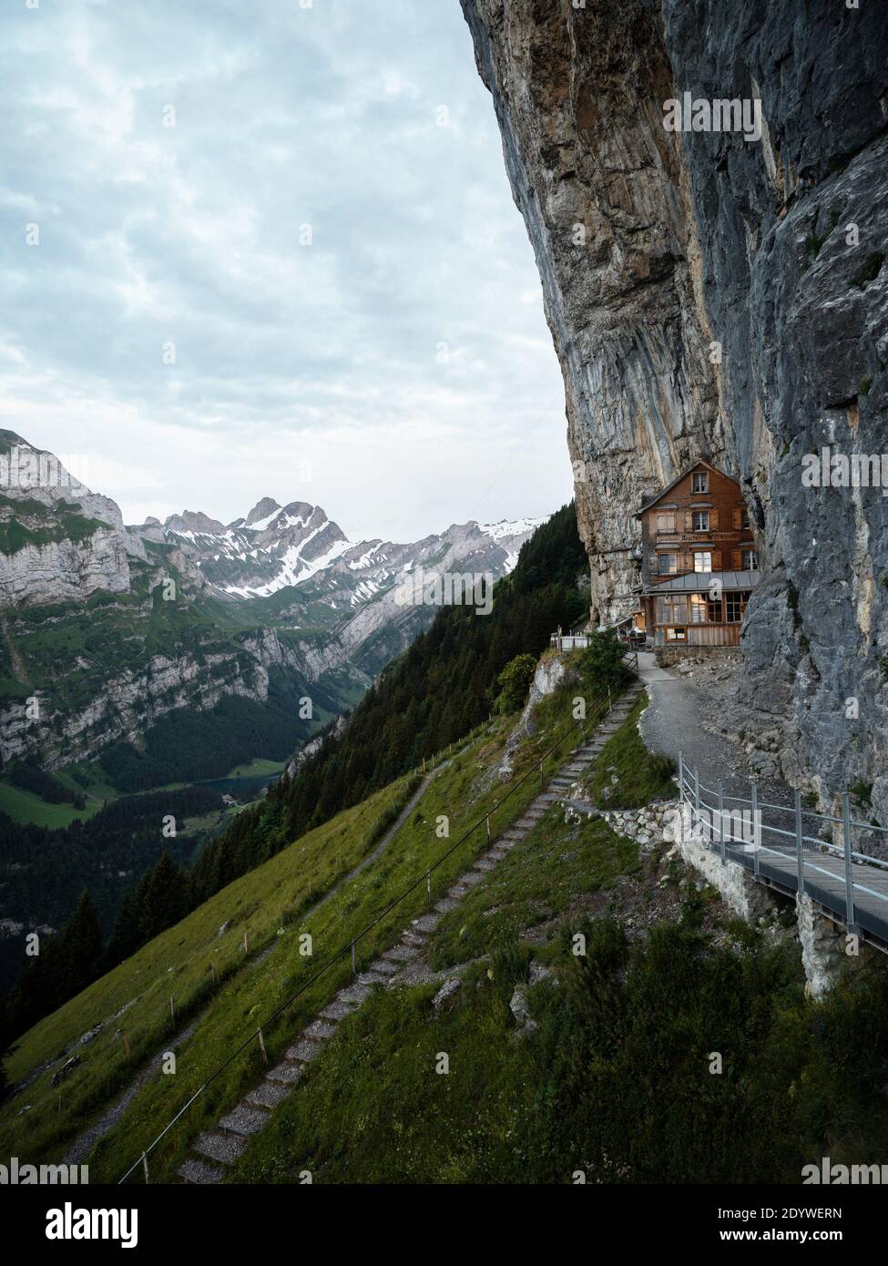 Famous guesthouse Aescher-Wildkirchli built into limestone cliff wall ...